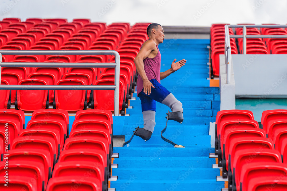 Asian male athlete with prosthetics, exercises by jogging in stadium ...