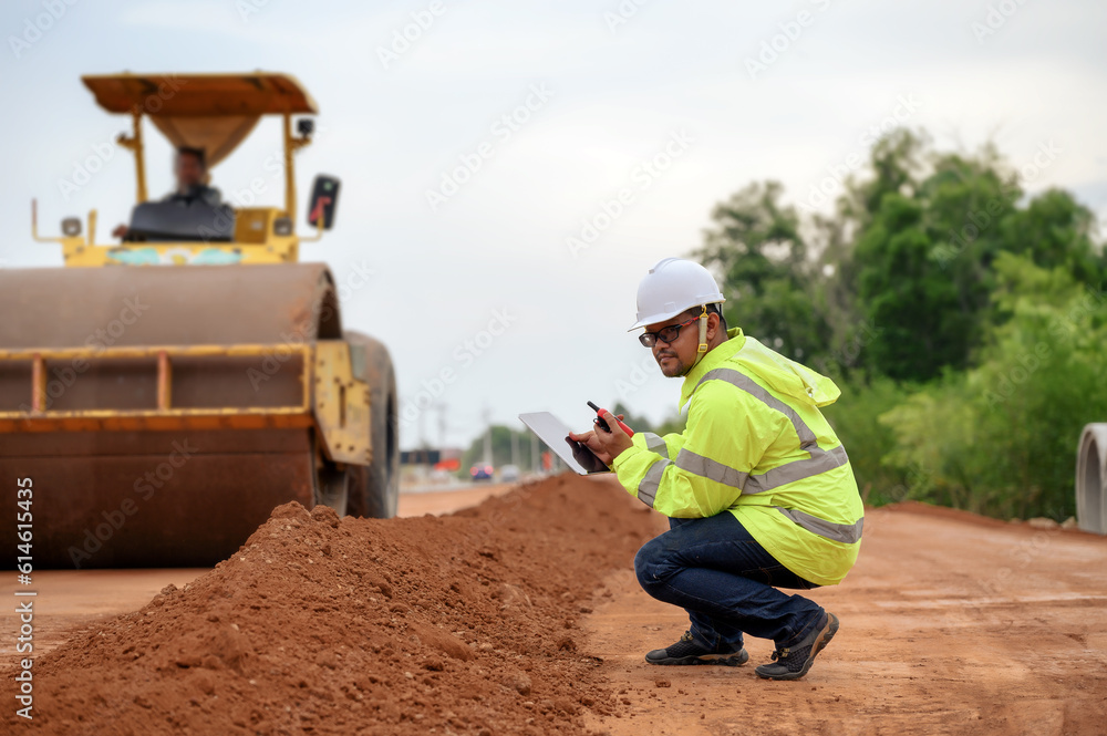 Asian civil engineers inspecting laterite soil for road construction ...