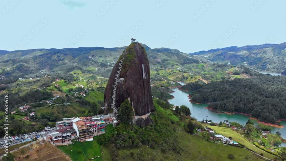 Aerial around El Peñón de Guatapé, a large and unique stand alone rock ...