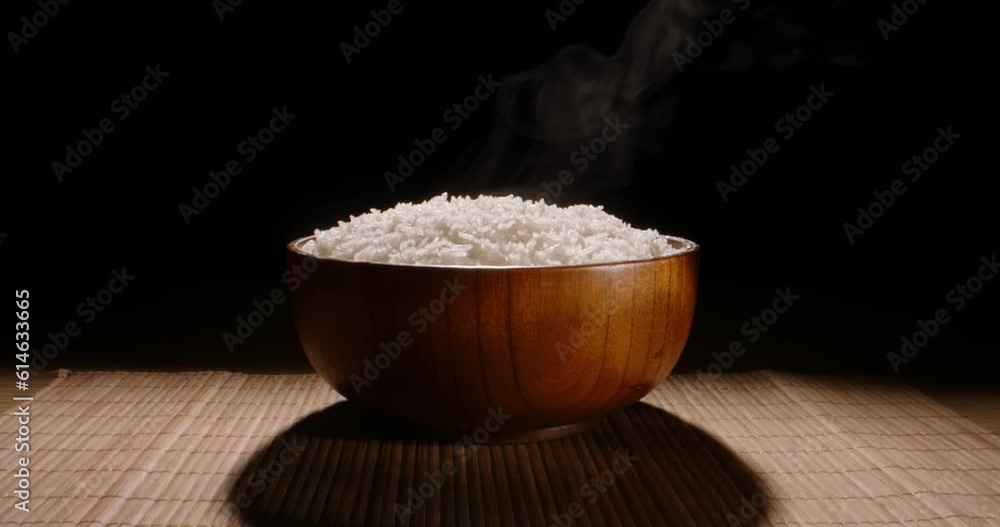 Hot white cooked rice steam bowl black background slow motion, Close up ...
