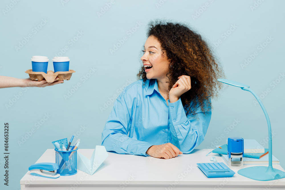 Young surprised employee business woman wear casual shirt sit work at ...