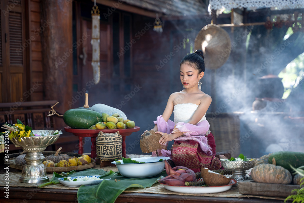 A little girl learns to cook Thai culture style. Asian girl wearing Thai dress costume ...
