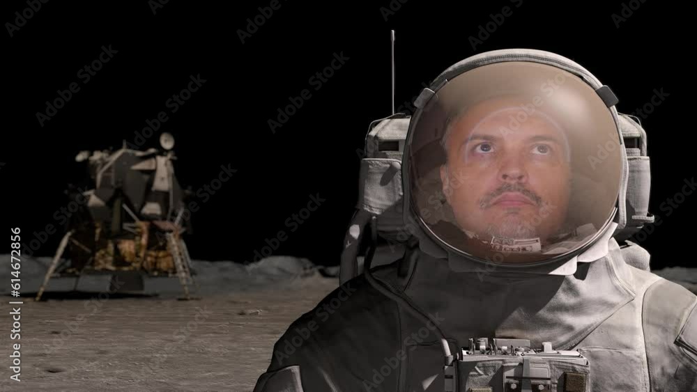 Portrait of man astronaut on Moon wearing helmet looking at earth globe ...