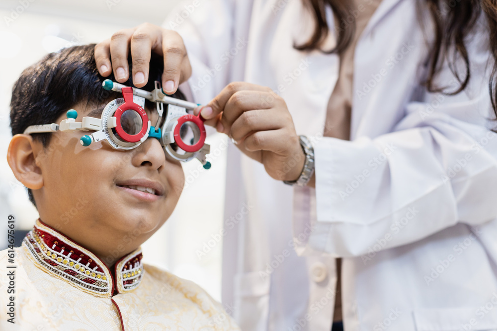 Happy Indian child boy examining eyesight modern ophthalmology ...