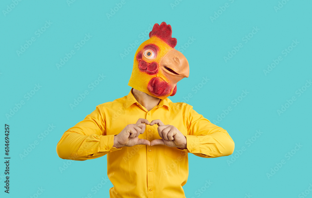 Funny man with comic romantic mood wearing chicken mask on his head ...