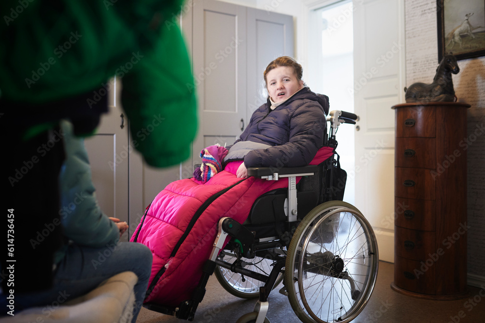 Disabled teenage girl sitting on wheelchair at home Stock Photo | Adobe ...