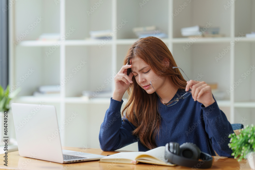 Sad teenager studying preparing for exam test in the university library ...