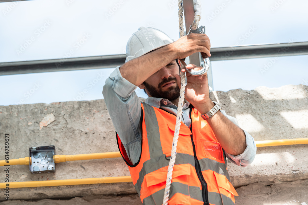 Construction worker men wearing safety sling climbing belt and hardhat ...