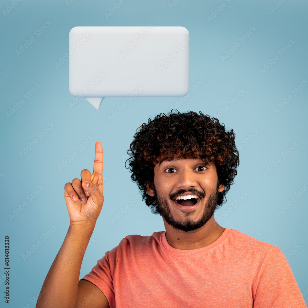 Indian guy pointing finger showing text bubble icon, blue background ...
