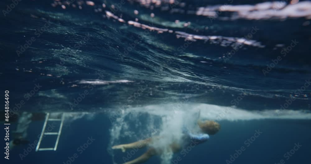 silhouette of sinking woman underwater, floating and diving under ...