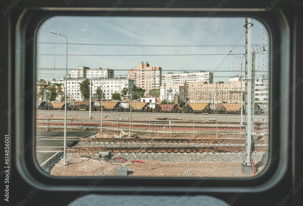 Train window view with old railway, clear blue sky, white and red brick ...