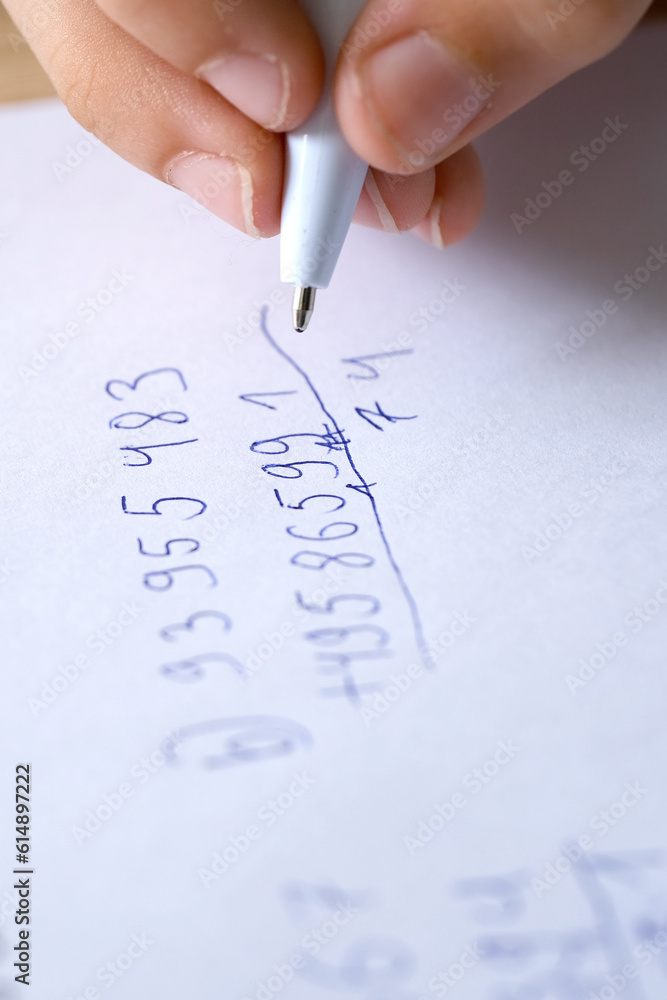 child, right-handed schoolchild hesitantly solves difficult task of ...