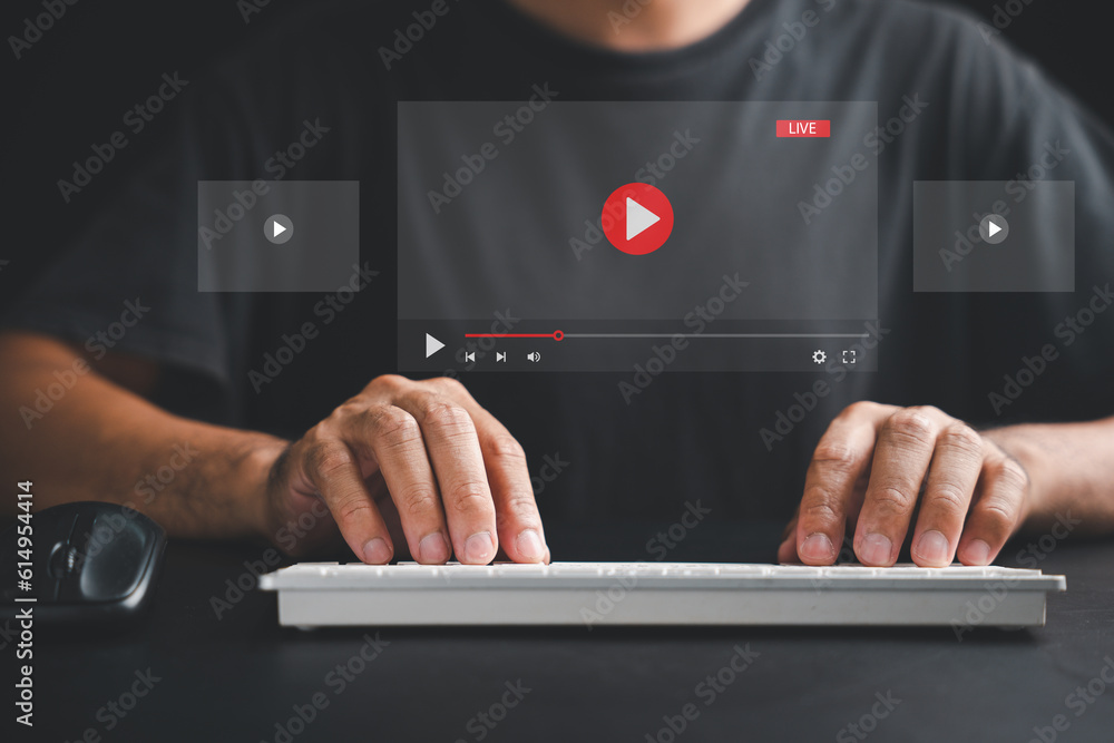 Man engaged in digital activities using a computer watching online ...