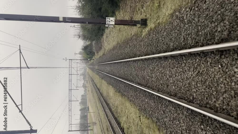 Vertical View on railroad track from the back window of fast Bullet ...