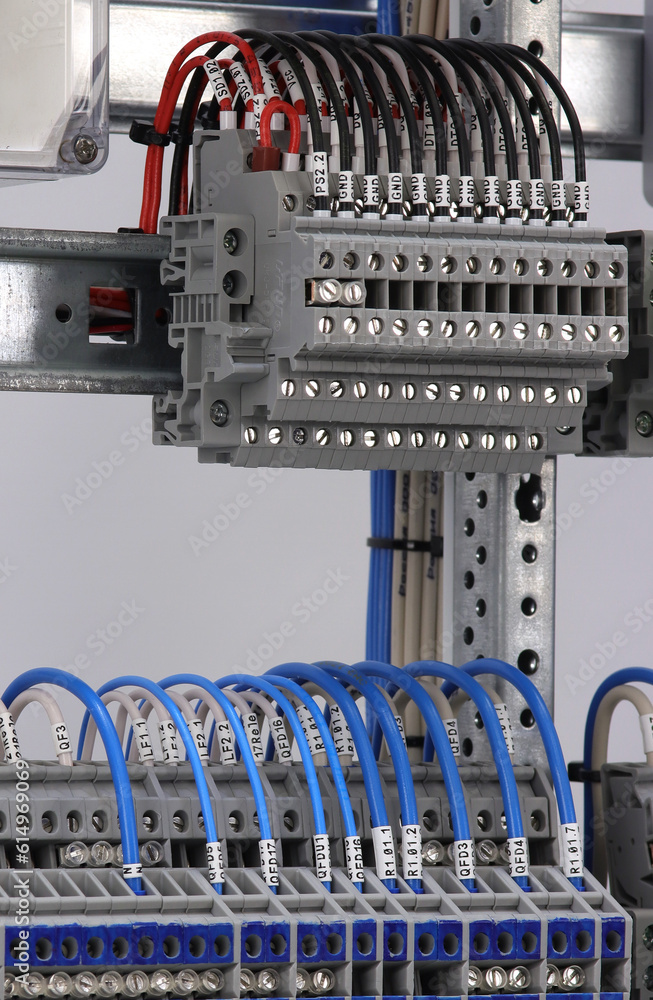 Electrical terminals with connected mounting wires are installed in an ...