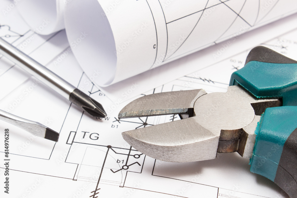 Pliers, screwdriver and diagrams of plan with electrical installation ...