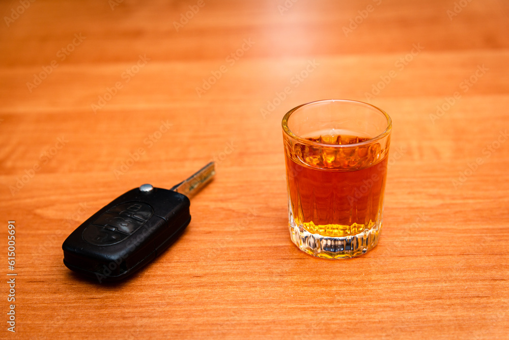 a glass of whiskey and car keys on the table.Drunk driving.Drink and ...