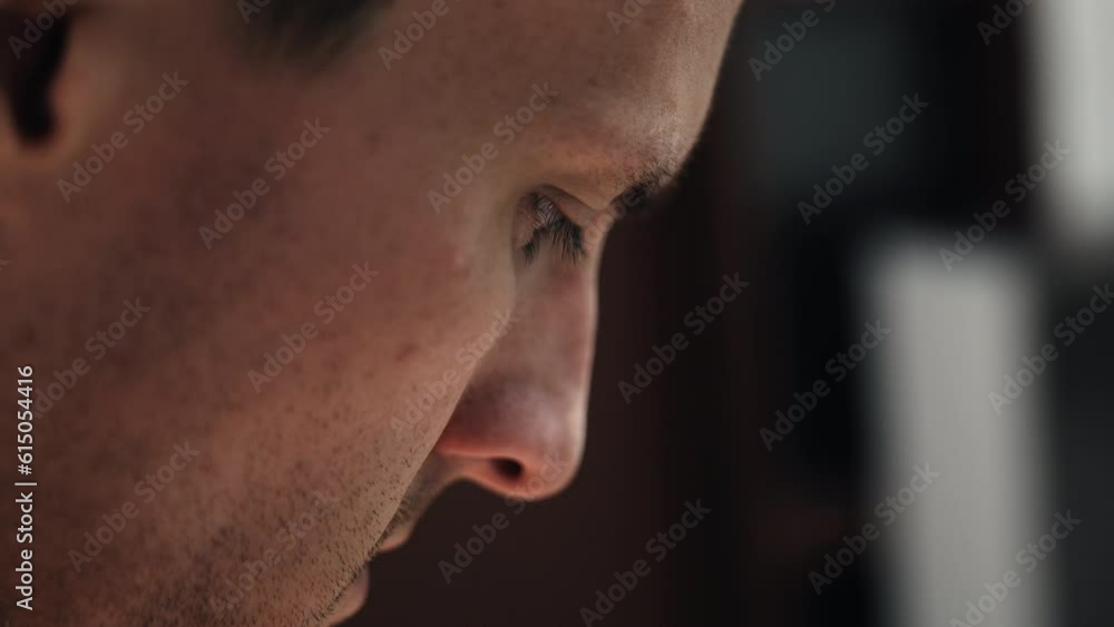 Closeup of face of man, prison inmate in prison cell. A sad, depressed ...