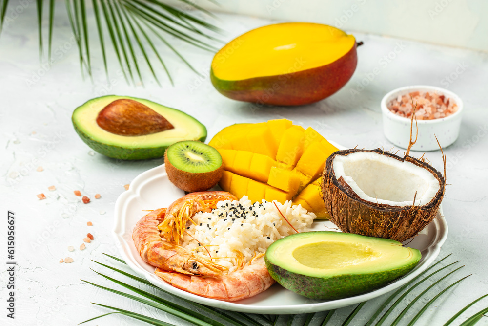 tropical bowl with avocado, prawns, rice, mango, kiwi and coconut ...