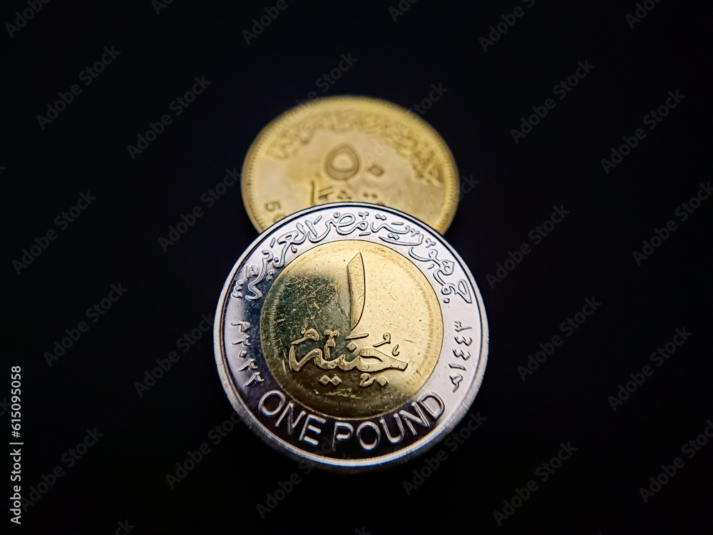 egyptian money ,one pound coin and 50 piasters coin isolated one black ...