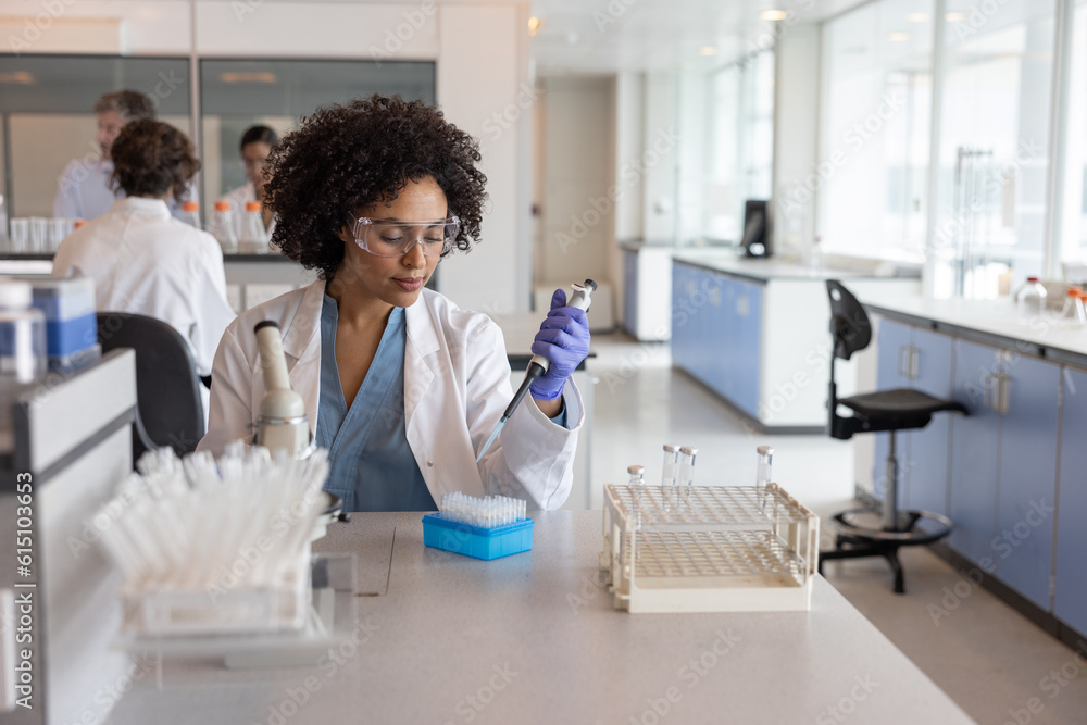 Female science student pipetting in laboratory Stock Photo | Adobe Stock