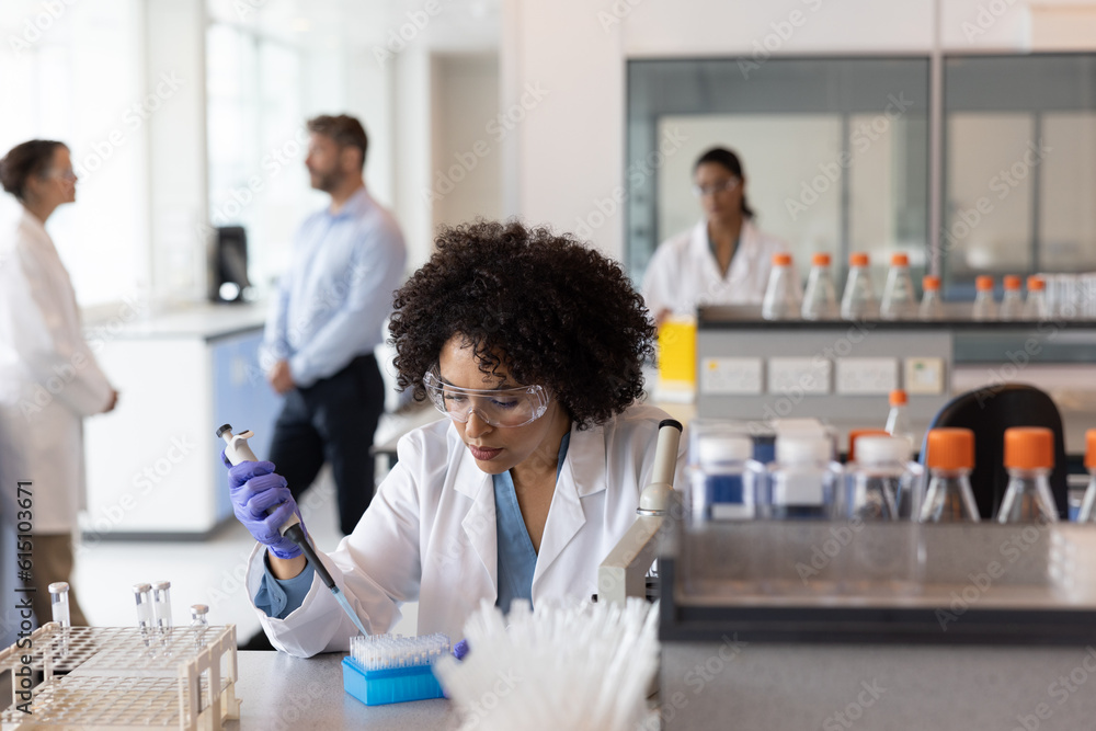 Female science student pipetting in laboratory Stock Photo | Adobe Stock
