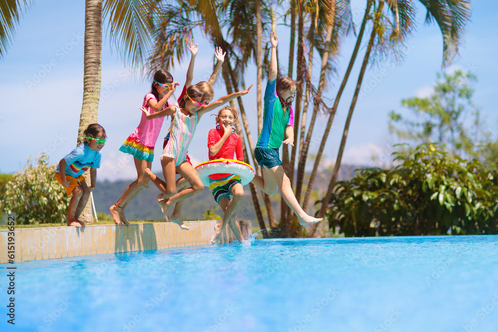 Kids jump into swimming pool. Summer water fun. Stock Photo | Adobe Stock