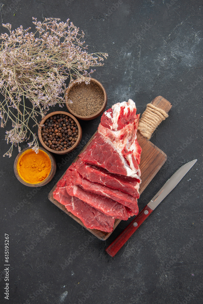 top view fresh sliced meat with seasonings on dark background meal ...