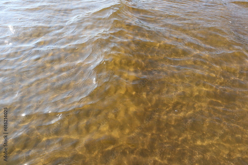 Beautiful background with transparent water and ripples on sandy bottom ...