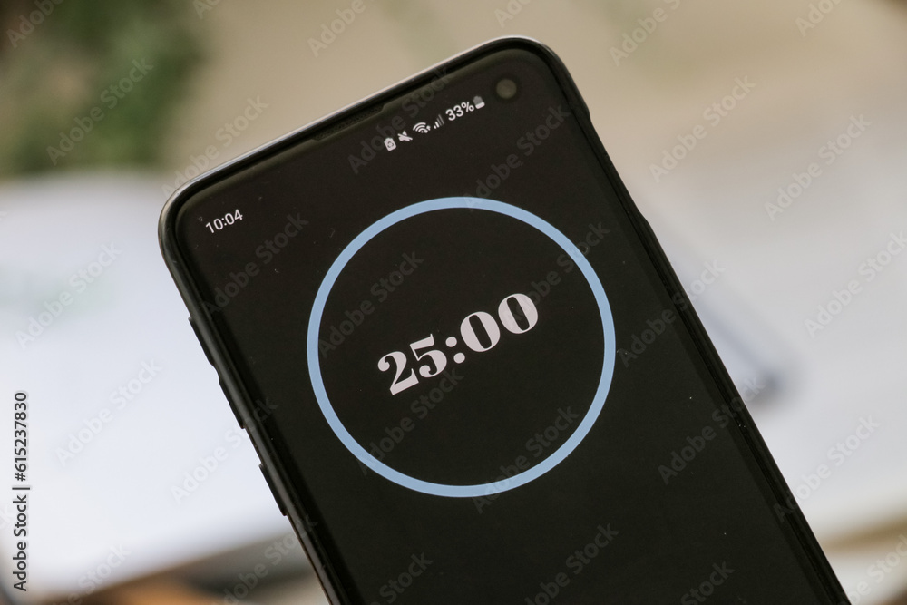 A phone with a black and white 25-minute timer to study with the ...