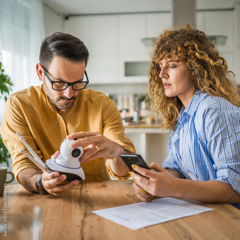Couple at home connect and install cctv security surveillance camera ...