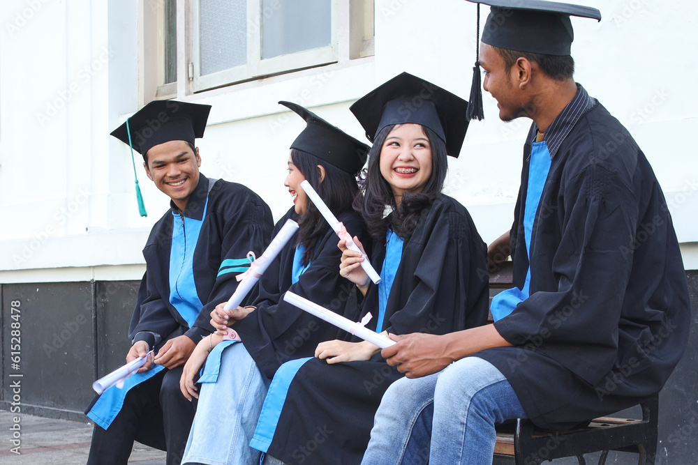 Group of graduated students sitting and chit chat with happines after ...