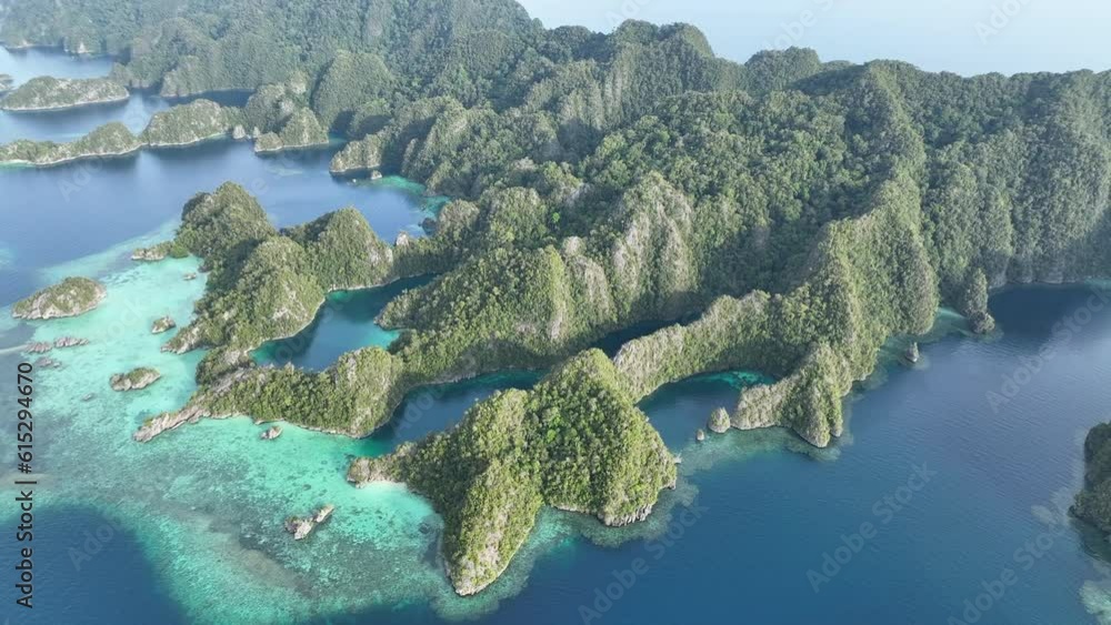 Dramatic limestone islands, eroded over millions of years, rise from ...