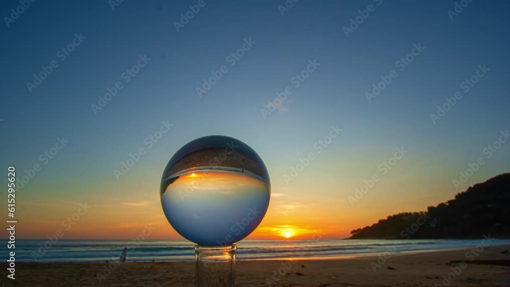 crystal ball sphere reveals sunset seascape with spherical perspective ...