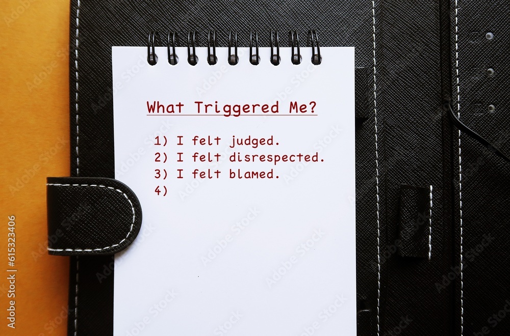 Notebook with handwritten text WHAT TRIGGERED ME? with list of Identify ...