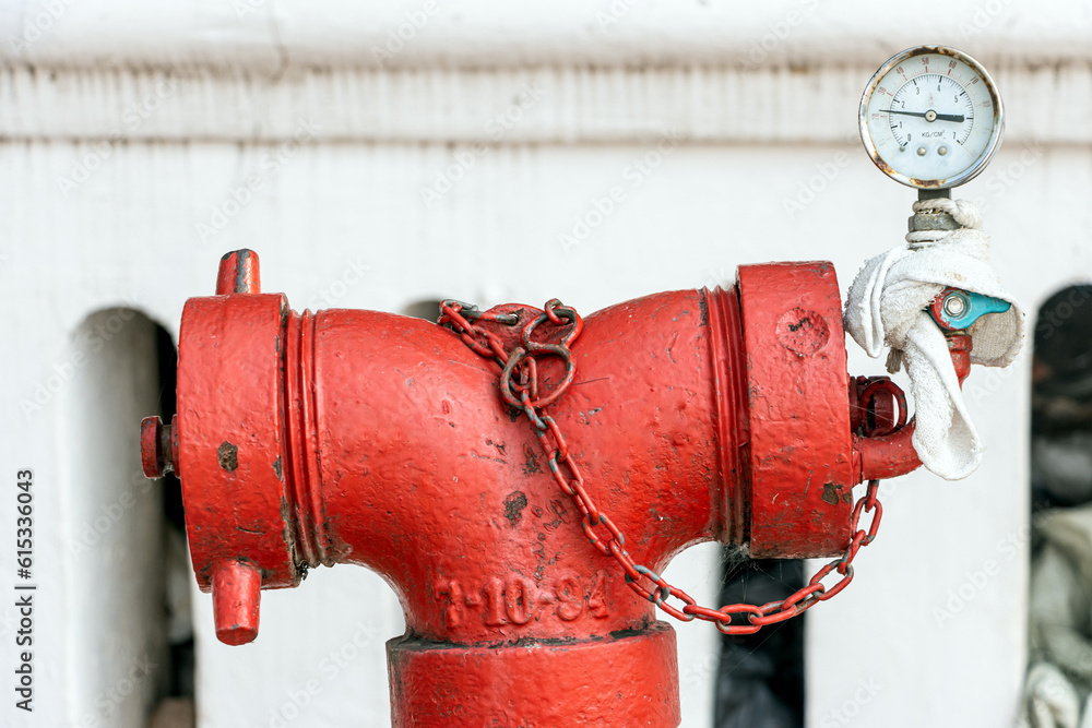 A hydrant with a pressure gauge on a city street Stock Photo | Adobe Stock