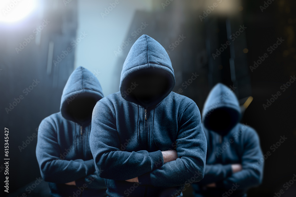 Dangerous criminal. Scary hooded guys at night in dark alley ...