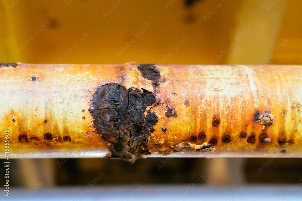 Steel pipe with blister paint, rust paint peeling off against the ...