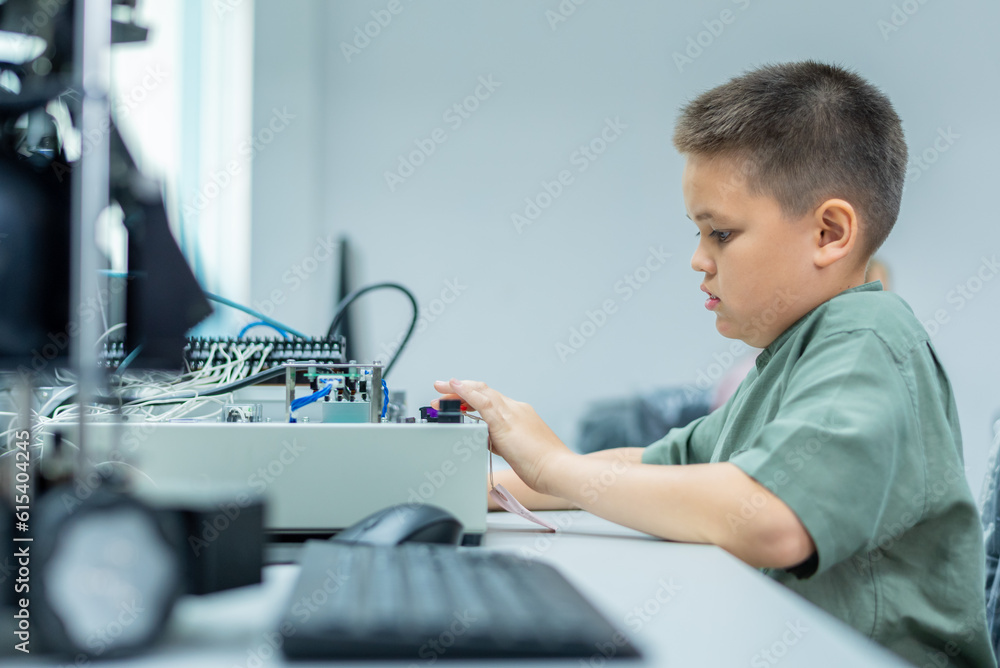 Boy male teen child concentrate enjoy Machine Learning Robot is Moving ...