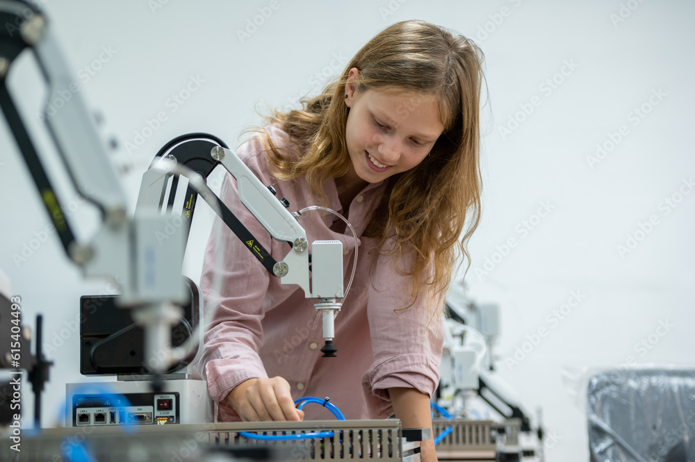 Kid female teen girl enjoy Machine Learning Robot arm is Moving Under ...
