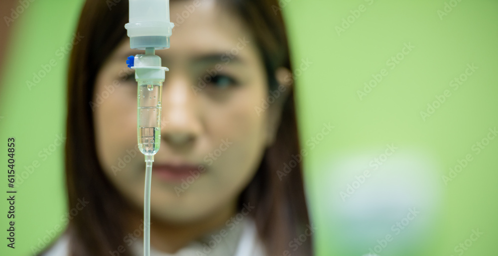 Woman doctor monitor Adjust the drip rate feed of saline dripping ...