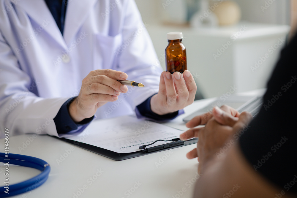 Doctor are recommending medicines to patients after being examined and ...