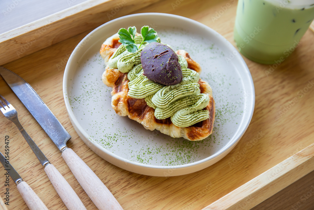 Closeup of Green tea waffles in a white plate with cutlery and cutlery ...