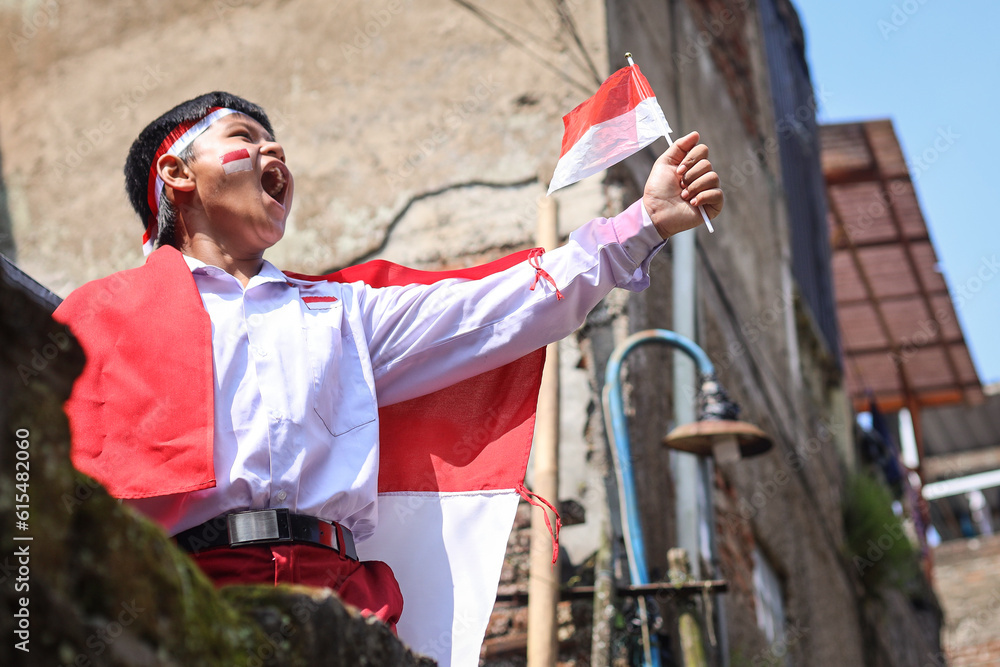 Indonesian school student wearing uniform is raising hands while ...
