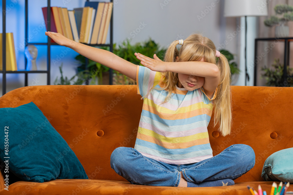 Trendy cheerful positive blonde toddler girl having fun dancing, moving ...