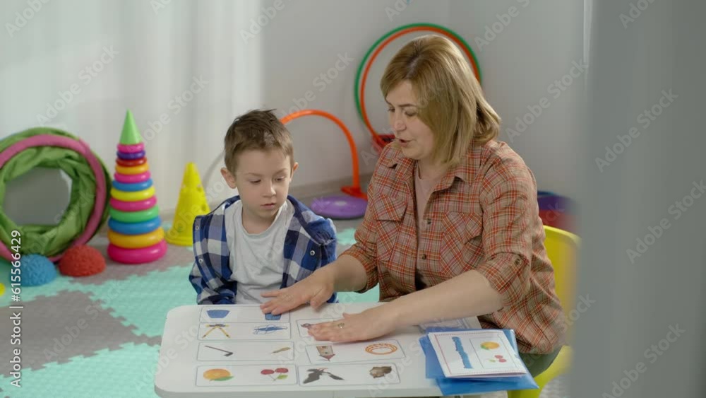 The teacher shows the child how to correctly perform tasks with ...