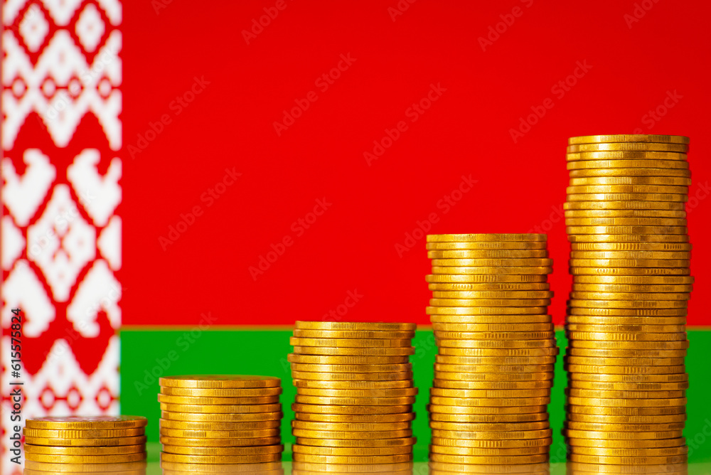 Stacks of bright gold coins near flag of Belarus. Development of ...