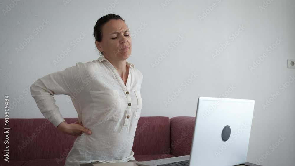 Woman suffer from sedentary work indoor. A woman with sedentary ...