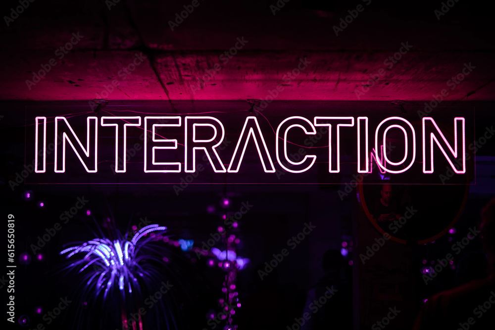 Interaction neon word lights dark pink industrial party carpark ...
