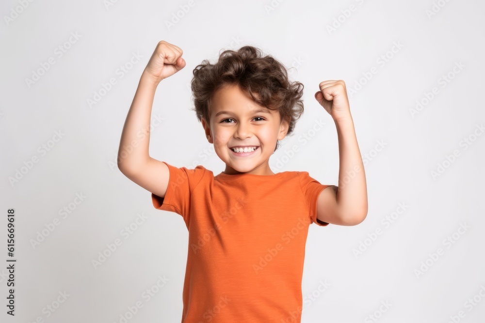 Portrait of a cute little boy showing his muscles on white background ...
